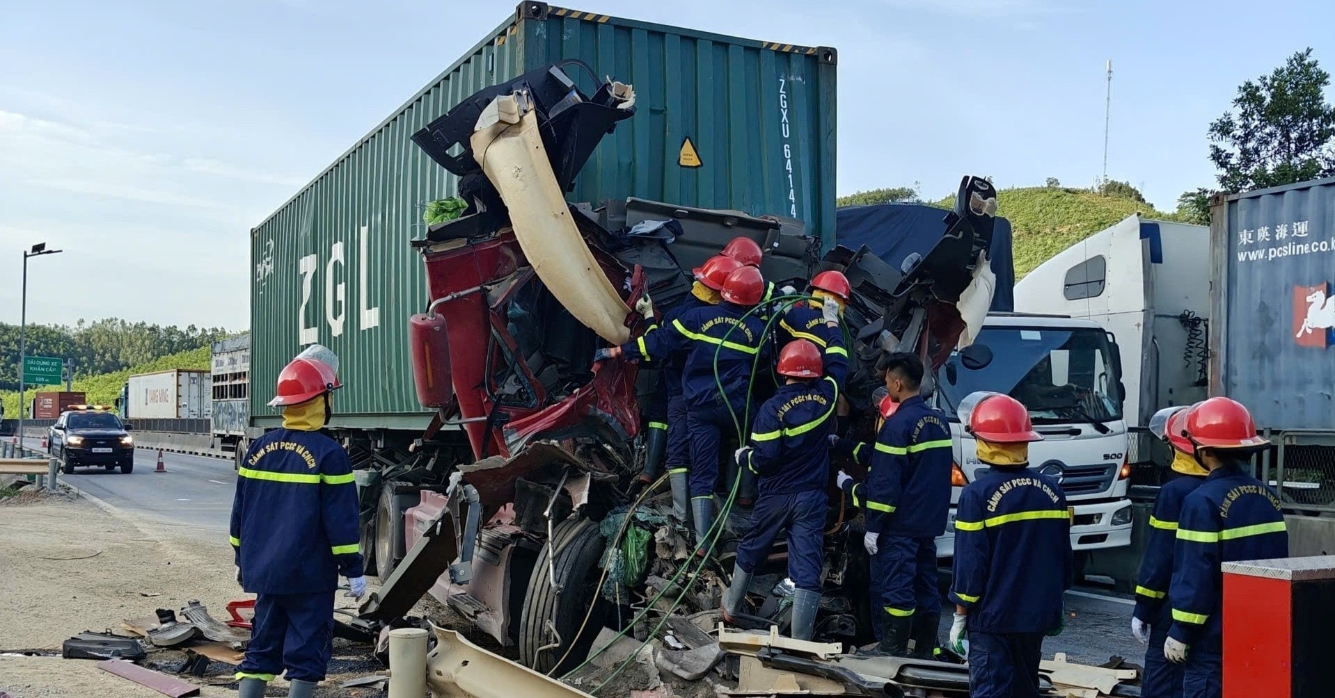 The cab of the tractor-trailer was cut open to remove the driver's body ...