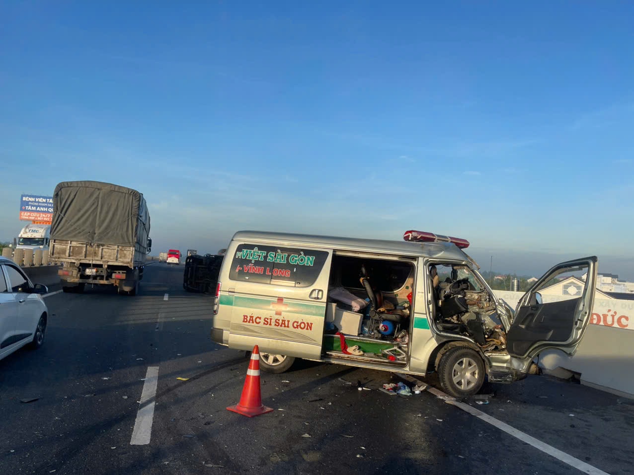 Collision on the highway: One car flipped over, one car deformed