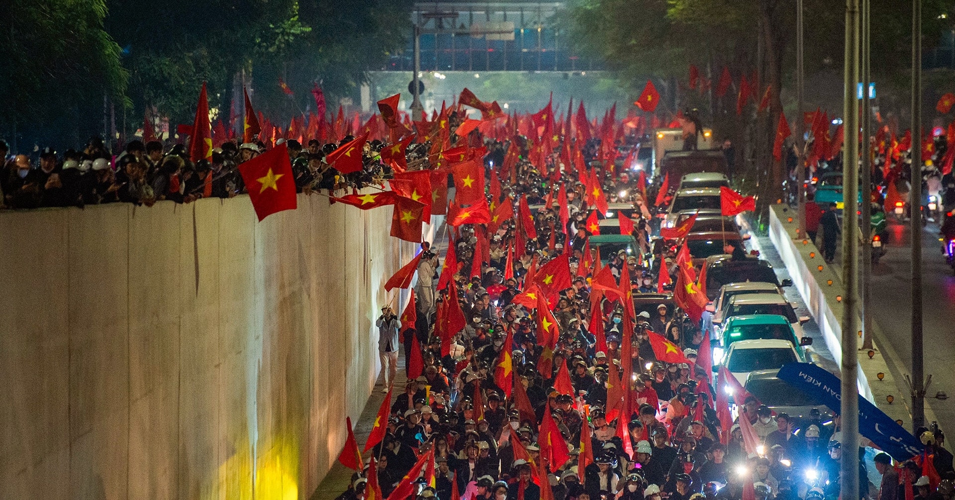 Hanoi and Ho Chi Minh City streets were ablaze with red flags at night ...